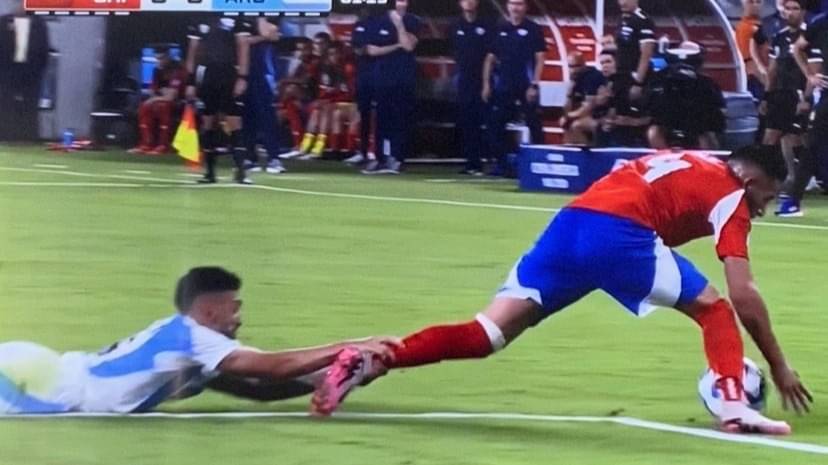 Argentina player stops Chile player by grabbing his feet with hands ...