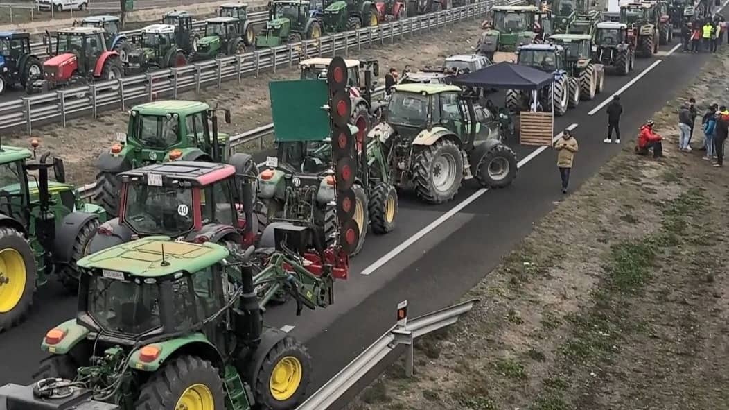 Farmers use tractors to block traffic on highways during protest in ...