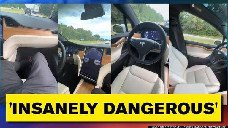 Driverless Tesla speeds down highway while man relaxes on passenger ...